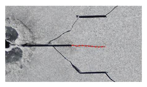 Crack Propagation Patterns Under Parallel Symmetrical Cracks In