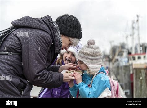A Grandmother Helps Her Granddaughter While Eating Stock Photo Alamy
