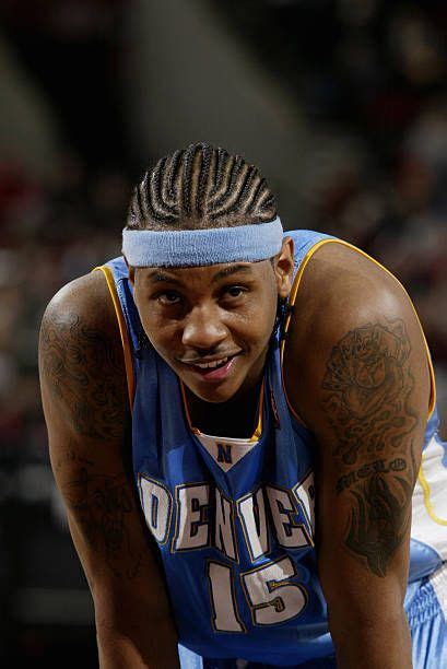 Carmelo Anthony Of The Denver Nuggets Rests On The Court During The