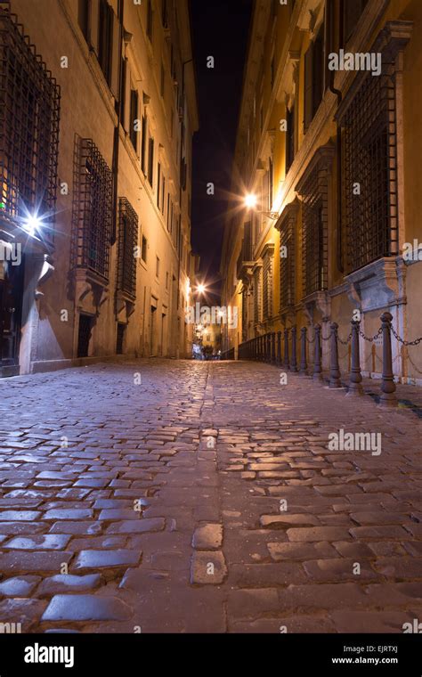 A View Of Sides Streets And Pedestrian Paths Between Buildings In Central Rome At Night Stock