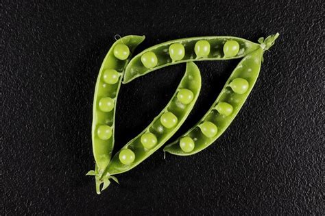 Premium Photo Two Open Pea Pods With Seeds