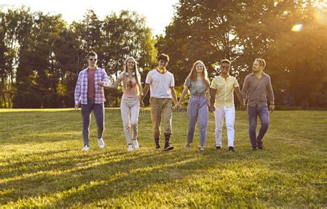 Diverse Group Of Happy Excited Friends Walking In The Park And Having