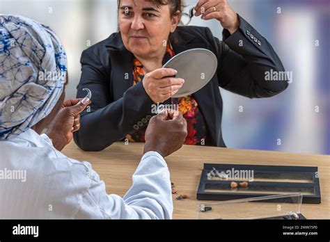 Patient Trying Different Types Of Hearing Aids Stock Photo Alamy