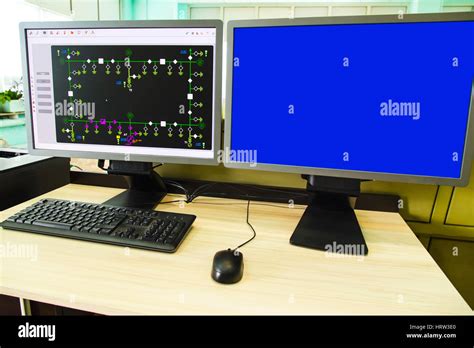 Computers And Monitors With Schematic Diagram For Supervisory Control And Data Acquisition In