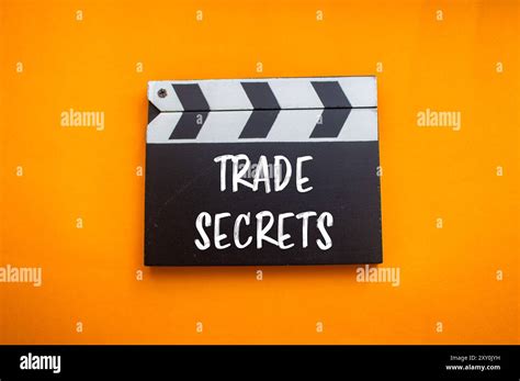 Trade Secrets Message Written On Movie Clapper Board With Orange Background Conceptual Trade