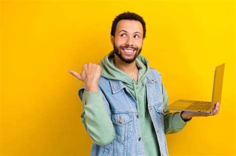Photo Of Handsome Programmer Guy Hold Netbook Look Direct Finger Empty Space Isolated On Yellow