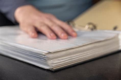 An Unfocused Shot Of A Man S Hand Resting On Top Of A File Folder Adult Male Placed His Hand On