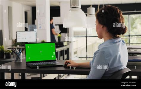 Manager Working With Greenscreen On Laptop Checking Isolated Mockup Template In Creative Agency