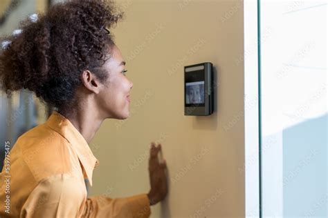 Woman Using Face Scanner To Unlock Door In Office Building Access