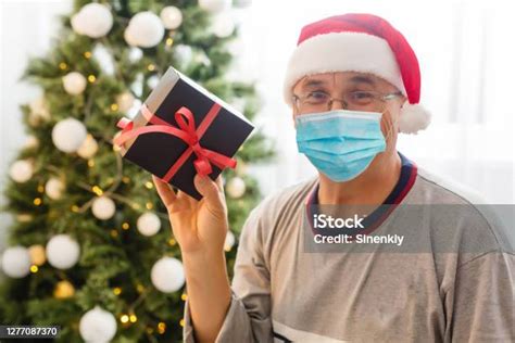 의료 얼굴 마스크와 산타 클로스 모자에 남자의 초상화 코로나바이러스 전염병 중 크리스마스 축하 2명에 대한 스톡 사진 및 기타 이미지 Istock