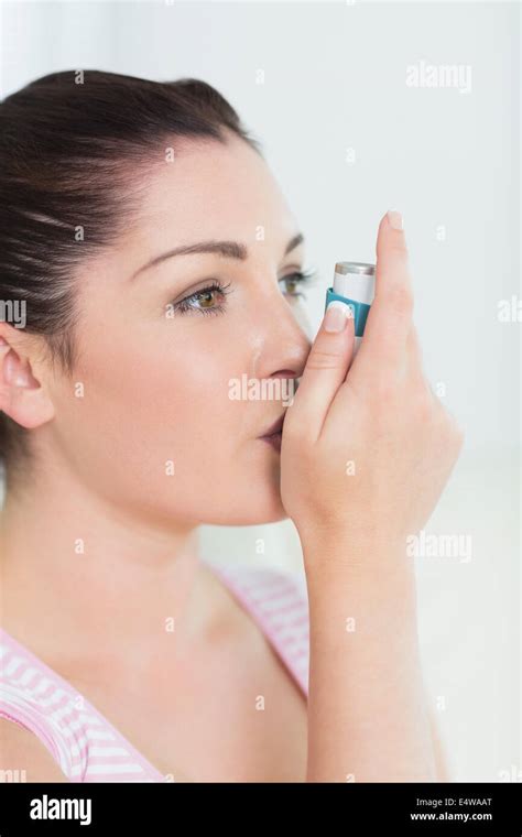 Woman With Asthma Using An Asthma Inhaler Stock Photo Alamy