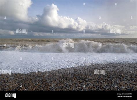 Colour Strong Sunlight Of Waves Breaking On Pebble Beach Surf Spume