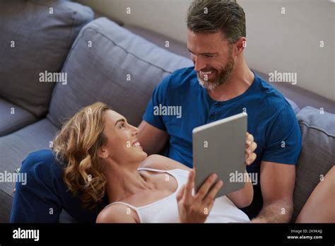 Lets Stay In And Stream Movies All Day A Happy Middle Aged Couple Using A Digital Tablet