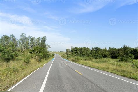 Straight Path Forward Of Asphalt Road And Blue Bike Path Shoulder Road