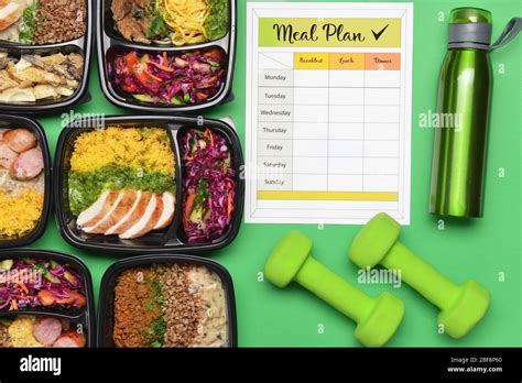 Containers With Healthy Food Bottle Of Water Dumbbells And Meal Plan