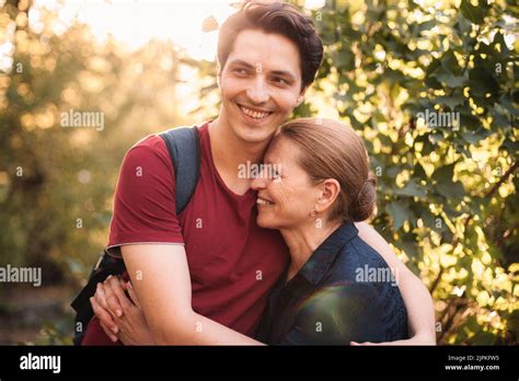 Happy Son Embracing Smiling Mother Outdoors In Summer Stock Photo Alamy