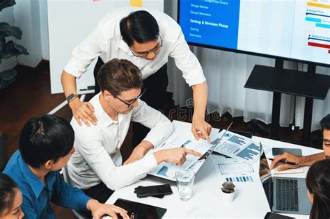 Analyst Team Utilizing Bi Fintech To Analyze Financial Data At Table