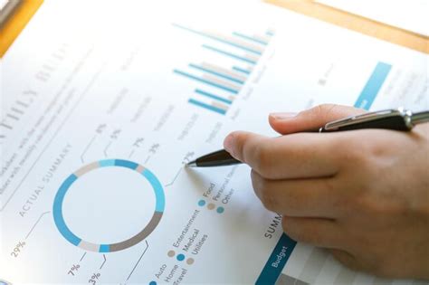 Premium Photo Close Up Of Businessman Writing In Graph At Office
