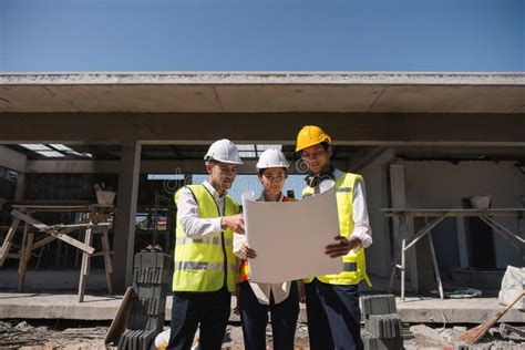 Team Of Professional Civil Engineers And Architects Holding Project Plan Paper Supervising And
