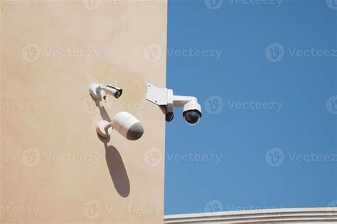 Security Cameras Mounted On A Building Under Clear Blue Sky 60259643