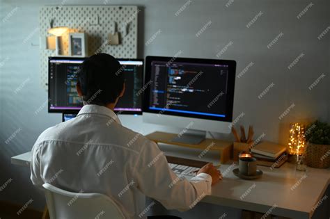 Premium Photo Focused Male Programmer Working With Coded Data On Computer Screen At Dark Room