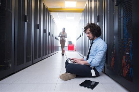 Premium Photo Team Of Young Technicians Working Together On Servers
