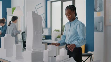 Man Analyzing Blueprints Plan And Building Model On Table To Design Construction Structure Stock