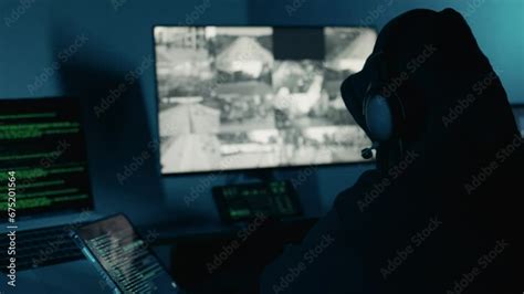 A Hacker Breaks Into Company Data Servers In Dark Atmosphere And Has Multiple Displays Hacker
