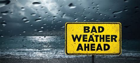 The Warning Sign Indicating Bad Weather Ahead By The Ocean Shoreline