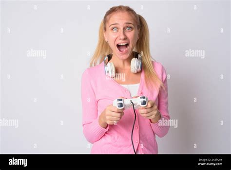 Portrait Of Happy Young Blonde Nerd Woman Playing Games And Winning