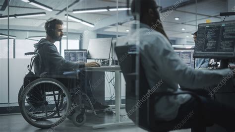 Software Developer In Wheelchair Working On Computer Stock Image