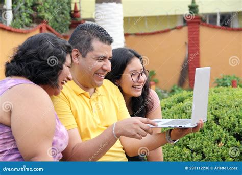 Dark Skinned Latino Dad And Daughters Use Laptop Together And Spend