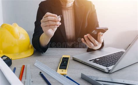 Construction Engineer Working At Blueprint To Build Large Commercial Buildings In Office