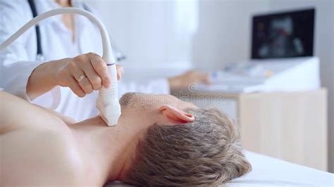 Doctor Woman Performing Neck Ultrasound Exam On Male Patient Medicine