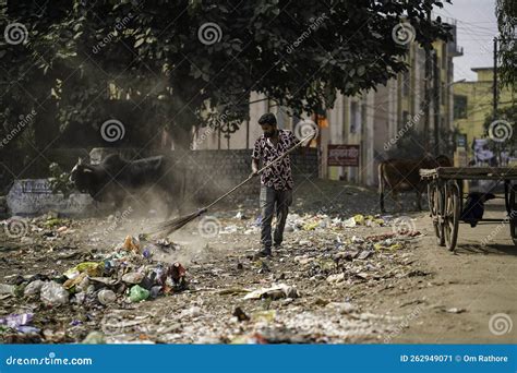 December Raipur India Man Sweeping The Trash With Broom And Big Garbage Area Polluted