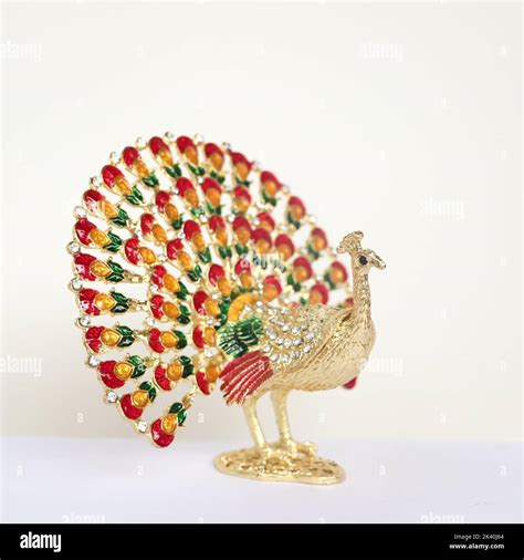 A Peacock Statue Made Of Beads Stones And Gold Isolated In A White