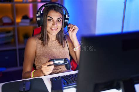 Young Beautiful Hispanic Woman Streamer Playing Video Game Using