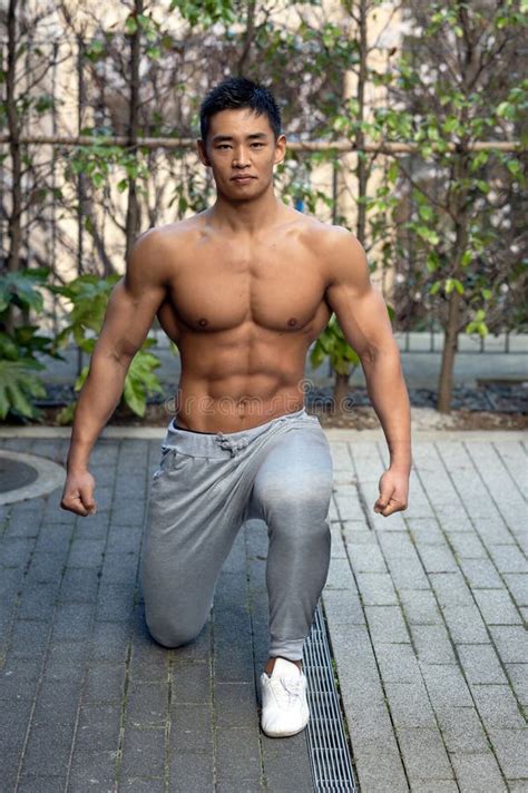 A Handsome Young Asian Bodybuilder Poses In A Park In Tokyo Stock Image