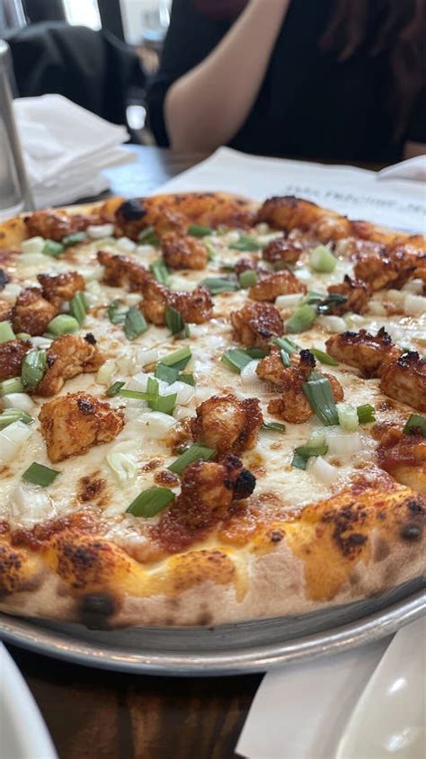 A Pizza Topped With Korean Gochujang Chicken And Scallions Stock
