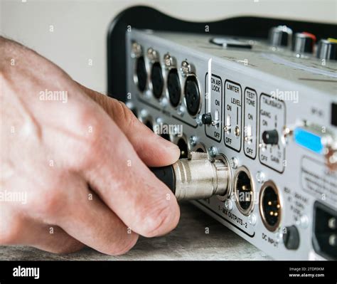 A Man S Hand Connecting An XLR Female Cable To The Output Of A Mixing Console Stock Photo Alamy