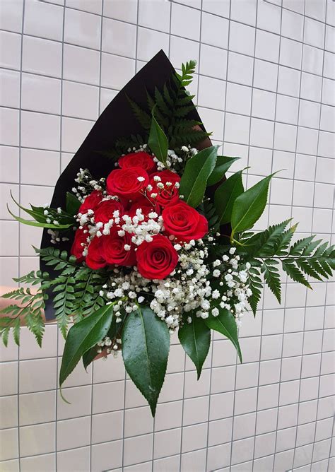 Two Dozen Roses Wrapped With Foliage Au