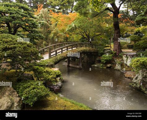 Japanese Stone Bridge Across A Stream In A Park Kyoto Japan Stock