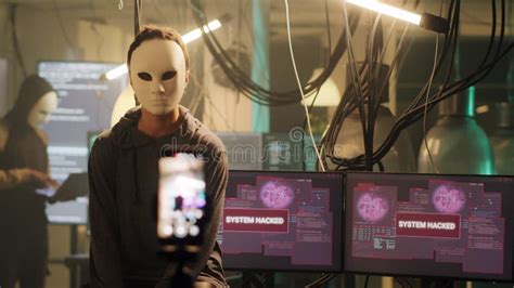 Female Hacker With Mask Broadcasting Live Threat Video Stock Footage