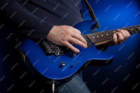 Premium Photo Musician Rock Guitarist Playing A Blue Guitar