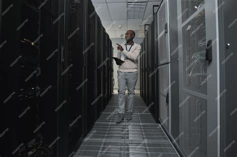 Premium Photo Technician Cybersecurity And Man In The Server Room For