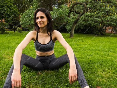 Premium Photo Portrait Of Teenage Girl Sitting On Grass