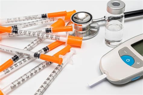 Premium Photo Glucometer And Insulin Syringe Lancing Device Tester Strip On White Background