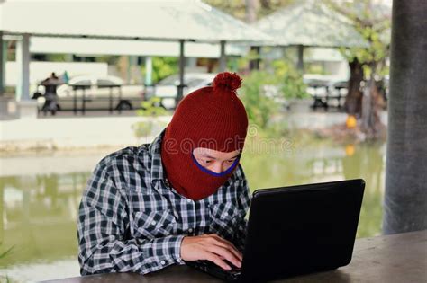Anonymous Hacker Hacking Steal Data With Laptop Social Crime Concept
