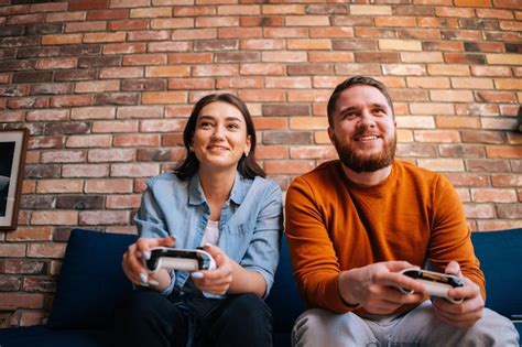 Premium Photo Closeup Portrait Of Happy Cheerful Young Couple Holding Controllers And Playing