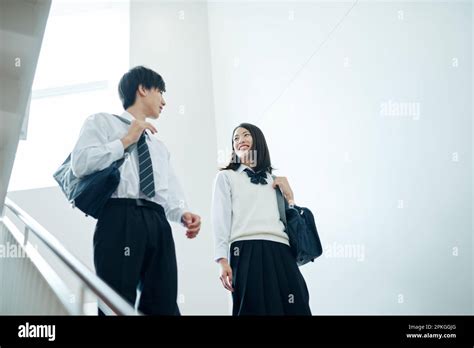 High Babe Babes Of Both Sexes Talking As They Move From One Classroom To Another Stock